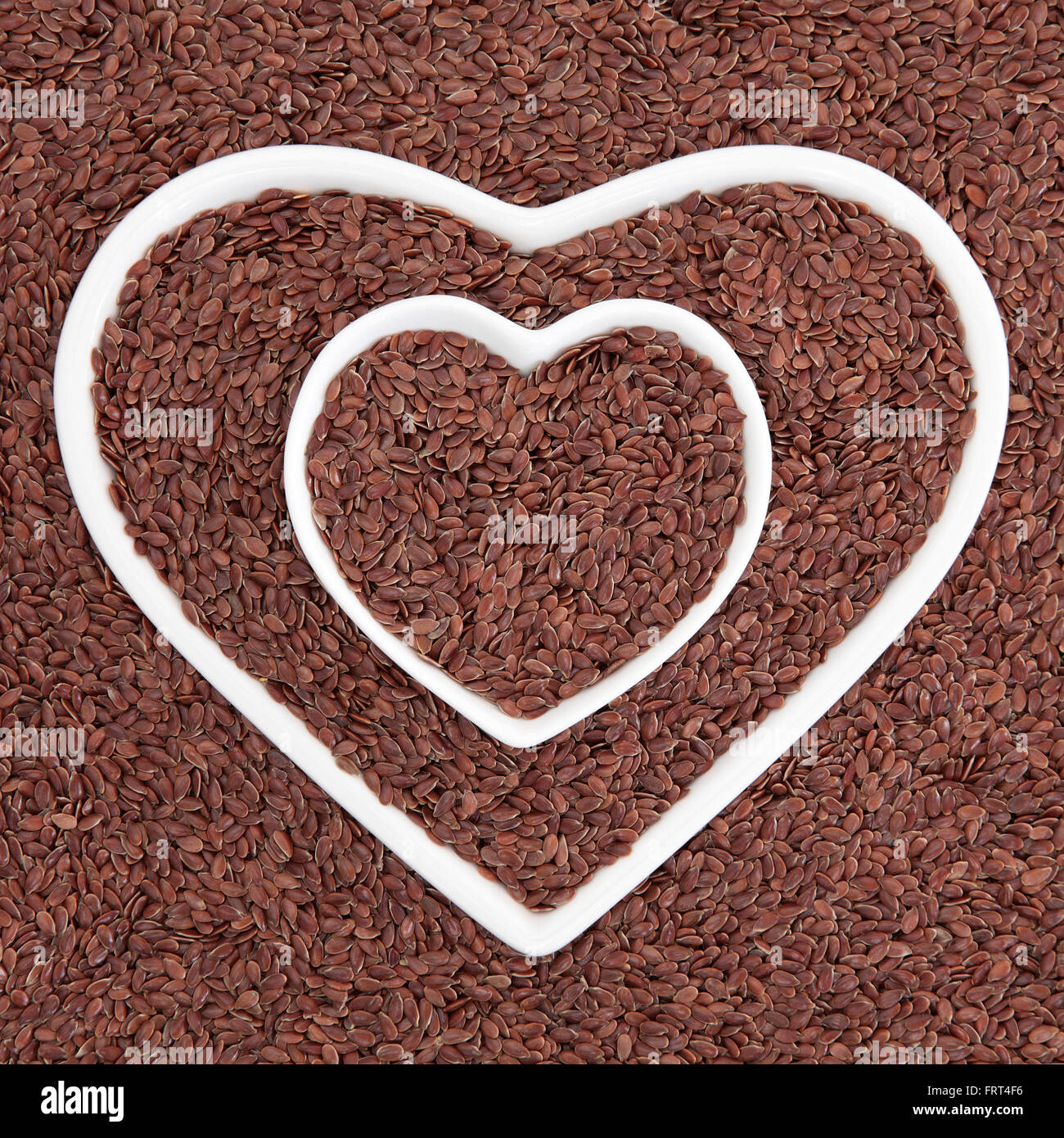 Flax seed health food in heart shaped porcelain bowls forming an ...