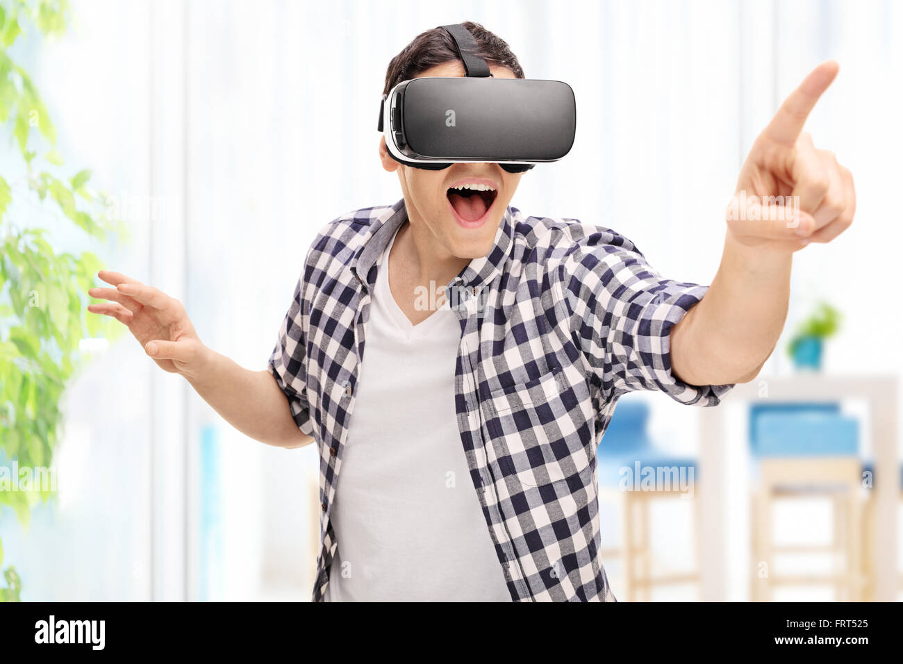 Excited young man watching something hi-res stock photography and ...