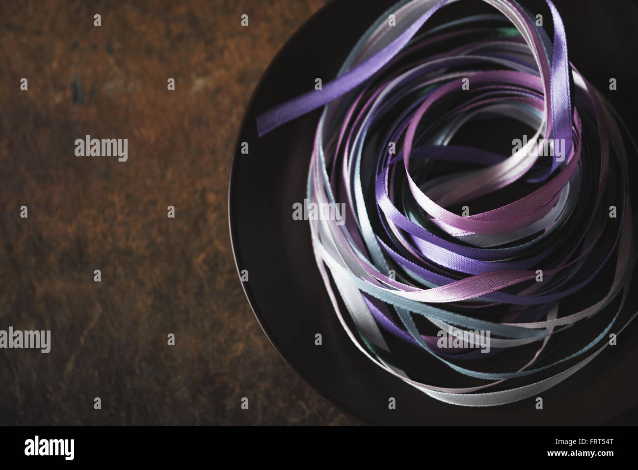 Blue ribbons in the plate top view Stock Photo - Alamy