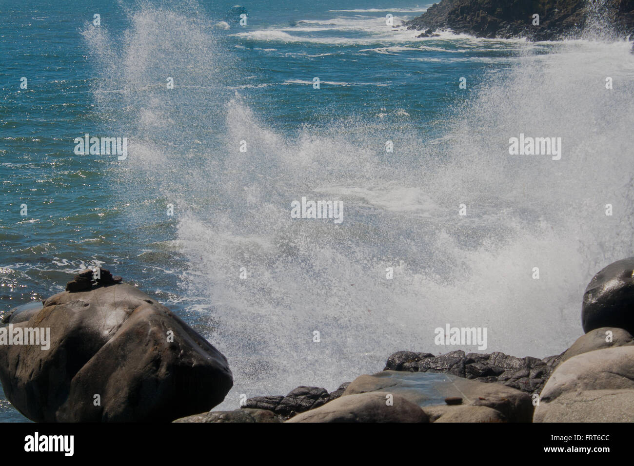 Forces of nature. The splash from a wave crashing the rocks below a ...