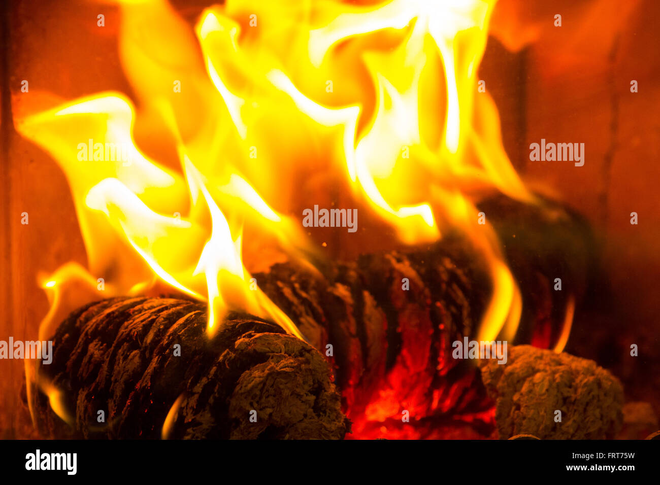 Log on fire burning billets in fireplace Stock Photo - Alamy