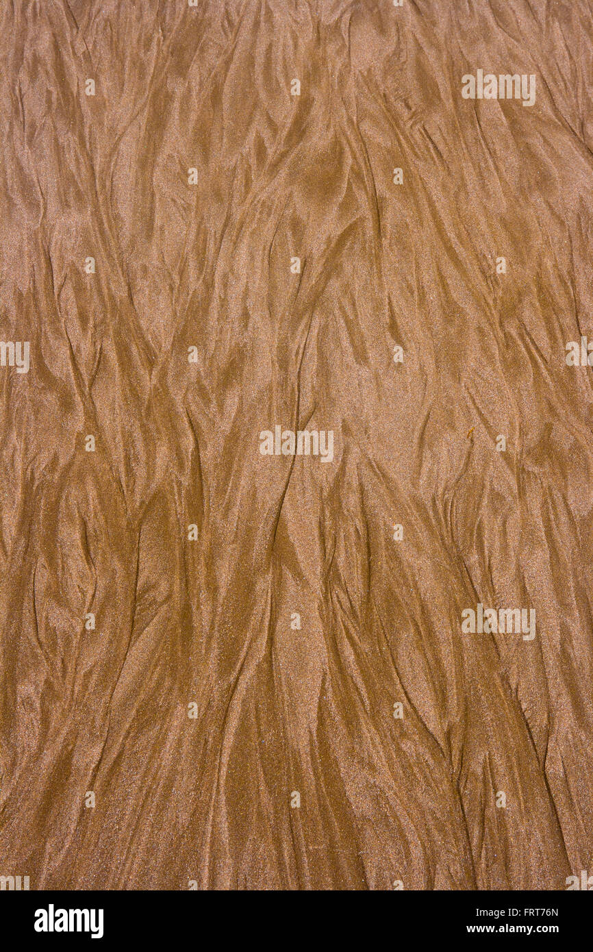 Receding water reveals a gorgeous, abstract, textured sandy beach Stock ...