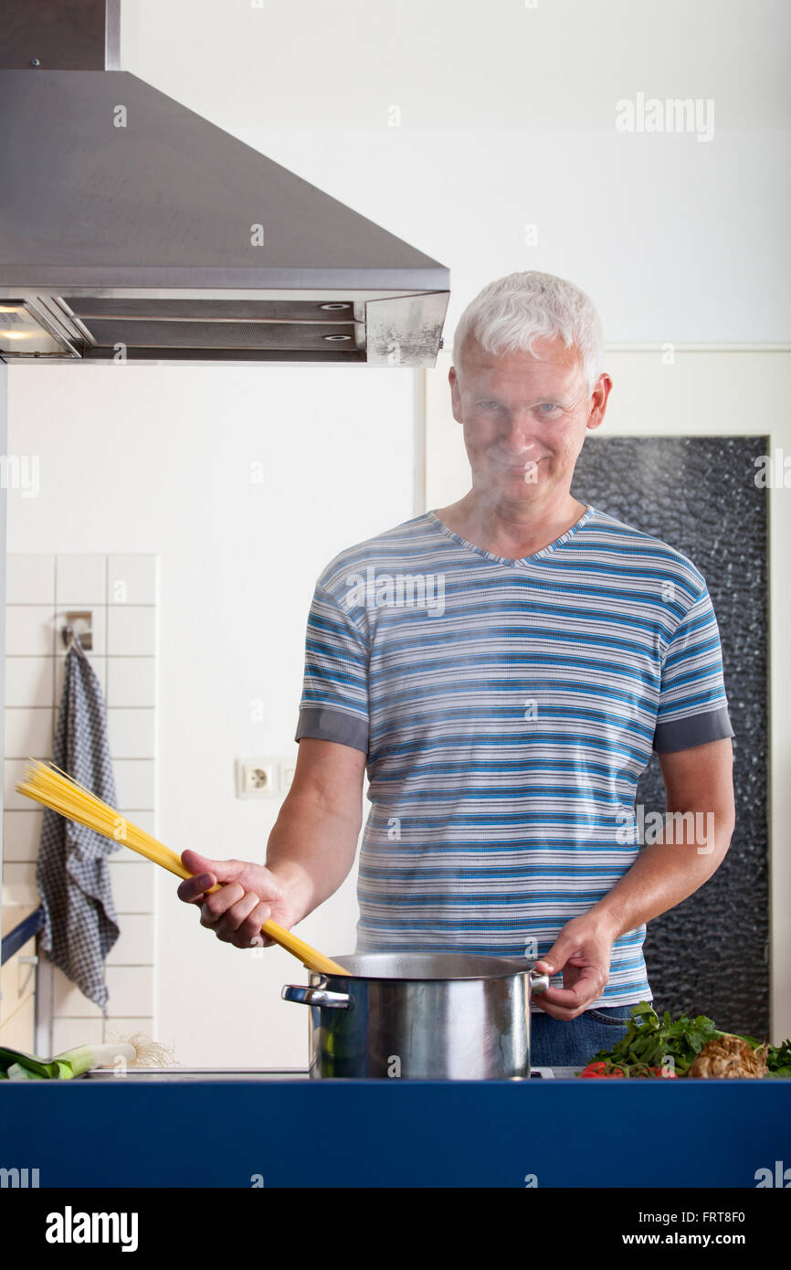 man cooking pasta in a kitchen Stock Photo - Alamy