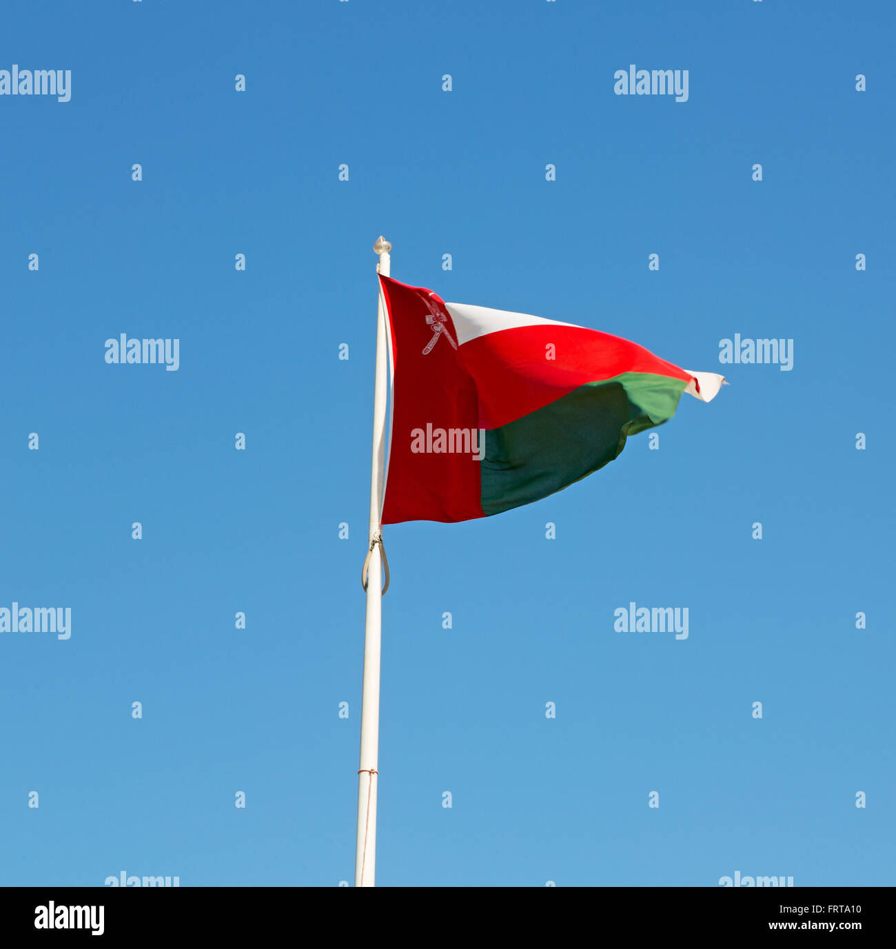 and the cloudy sky in oman waving flag Stock Photo - Alamy
