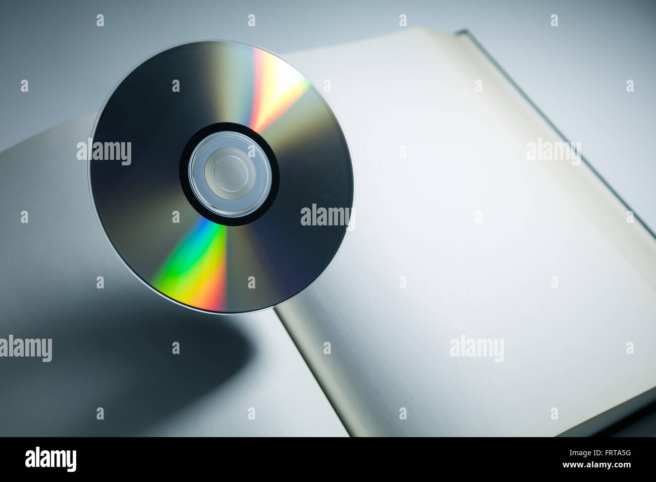 Book and DVD disk with dark shadow , education concept Stock Photo - Alamy