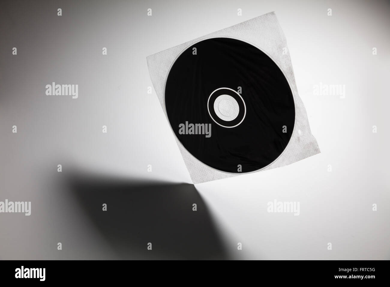 a CD , DVD disk with dark shadow , technology concept Stock Photo - Alamy