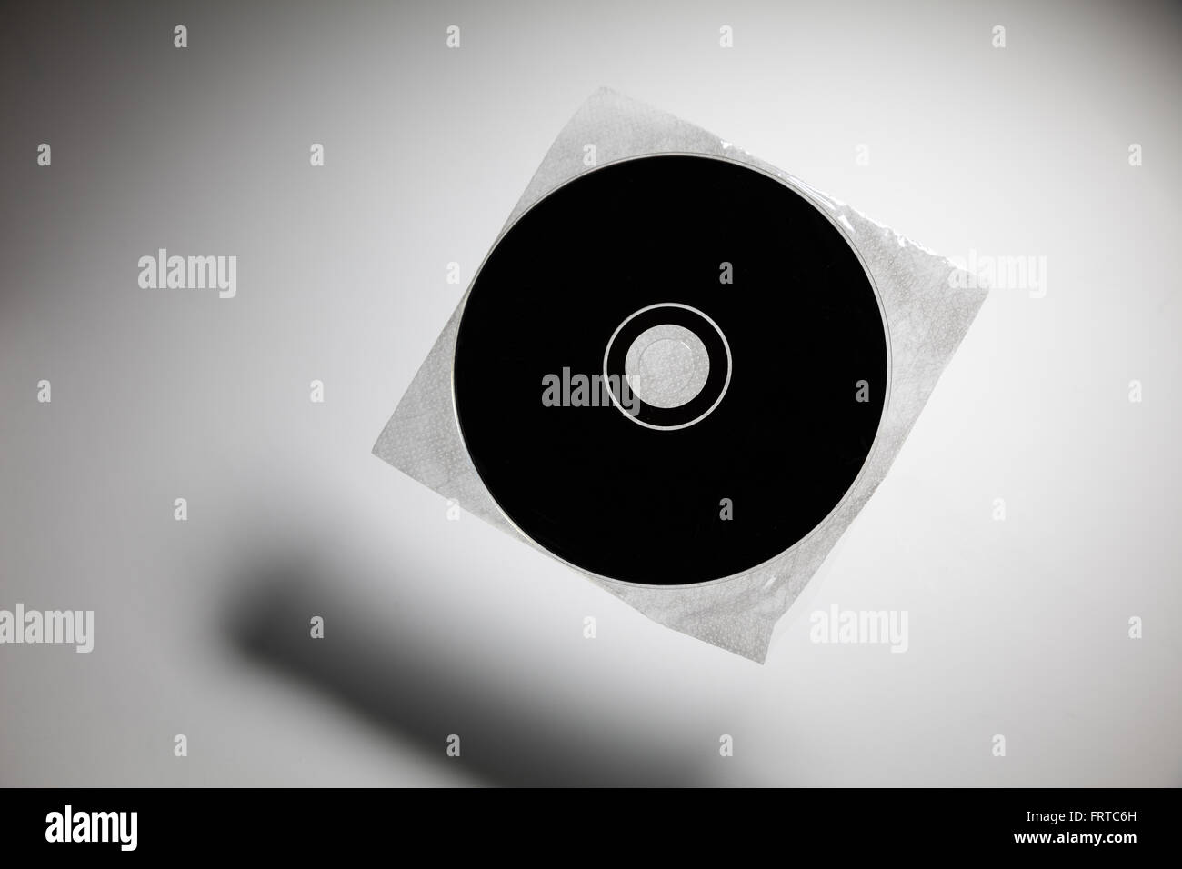 a CD , DVD disk with dark shadow , technology concept Stock Photo - Alamy