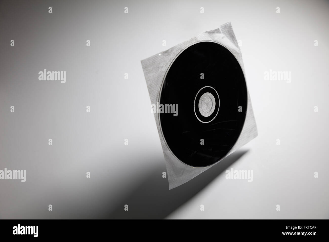 a CD , DVD disk with dark shadow , technology concept Stock Photo - Alamy
