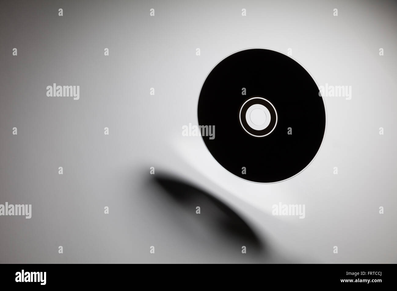 a CD , DVD disk with dark shadow , technology concept Stock Photo - Alamy