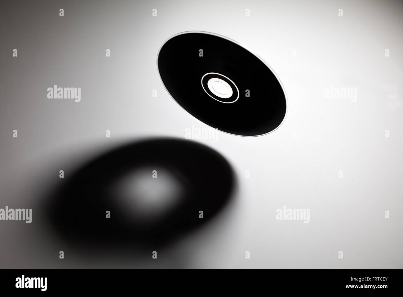 a CD , DVD disk with dark shadow , technology concept Stock Photo - Alamy