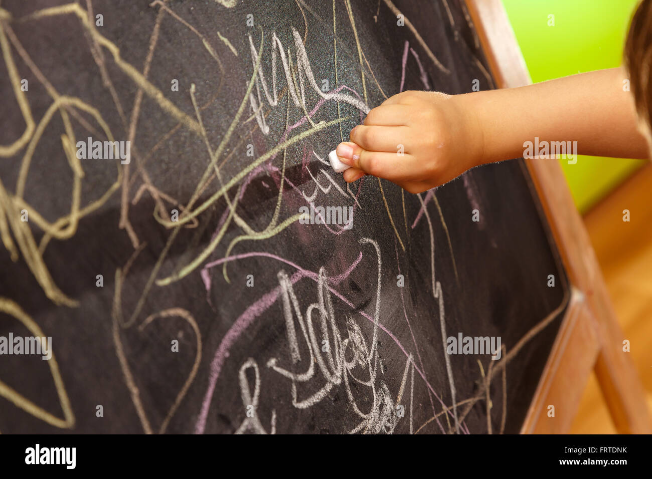 Child's hand drawing with chalk on blackboard Stock Photo - Alamy
