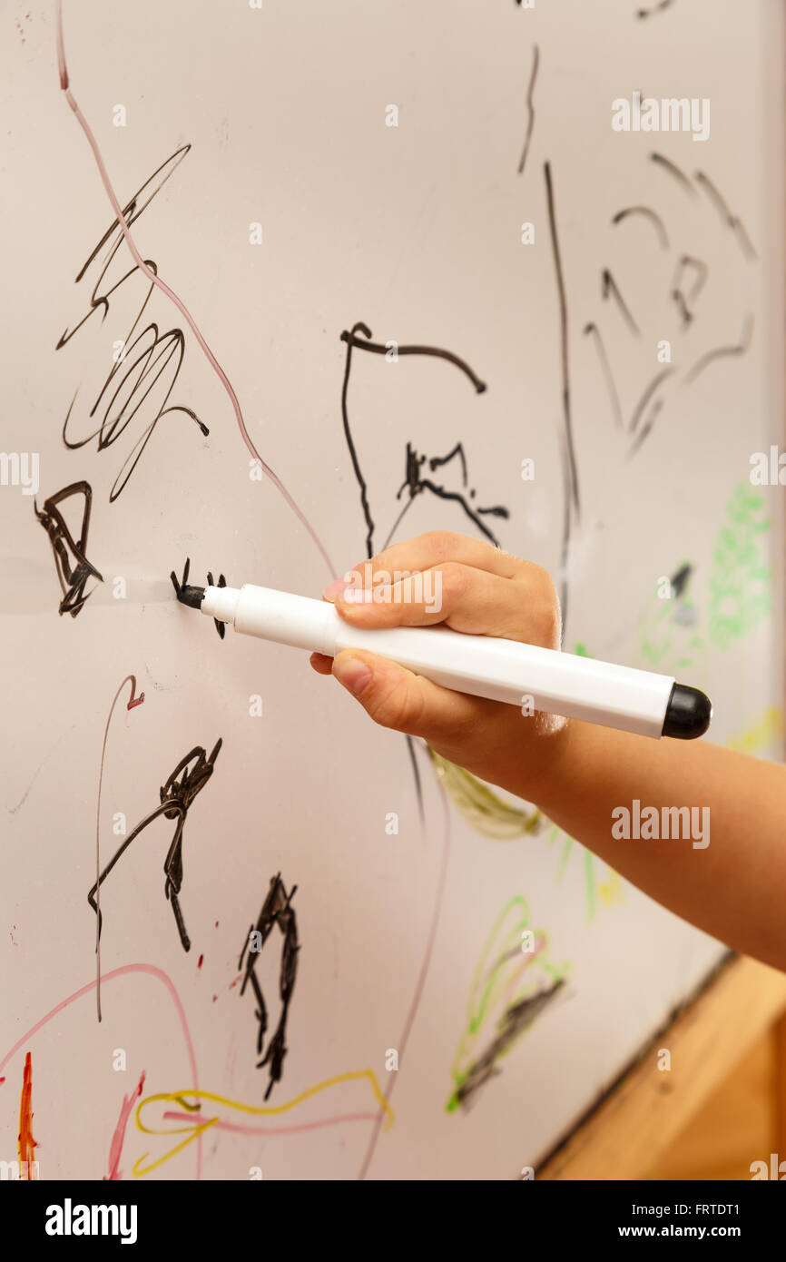 Child's hand drawing with marker on blackboard Stock Photo - Alamy