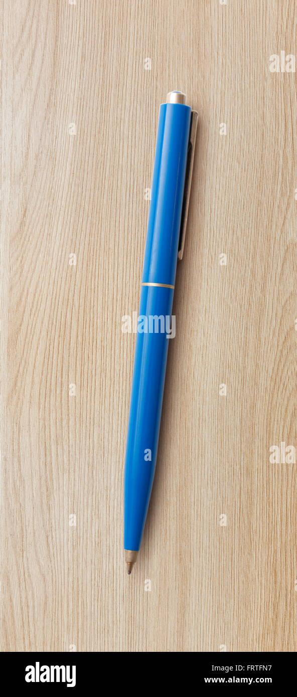 Blue pen in closeup on wooden background Stock Photo - Alamy