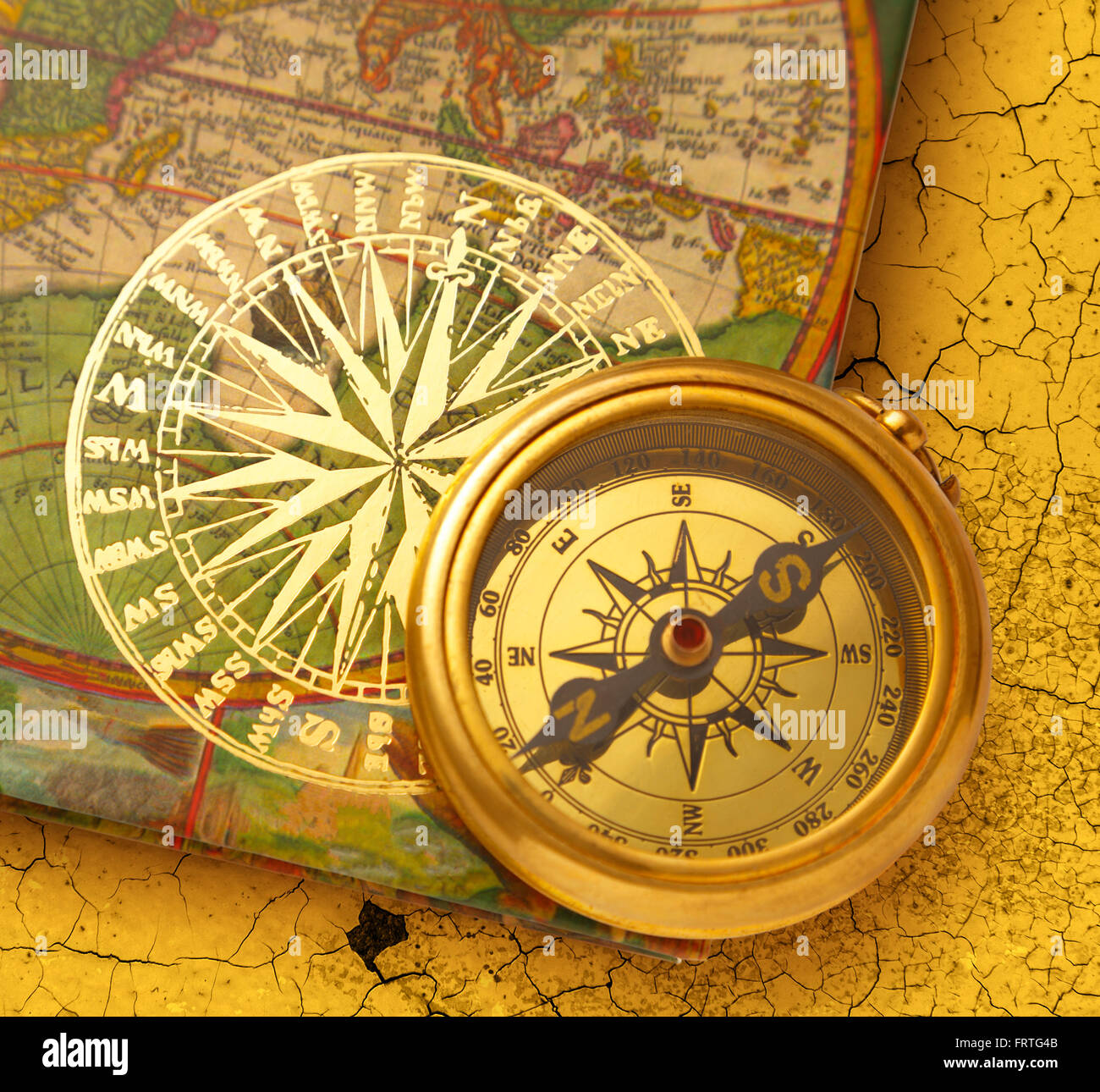 Book with retro golden compass on it Stock Photo - Alamy