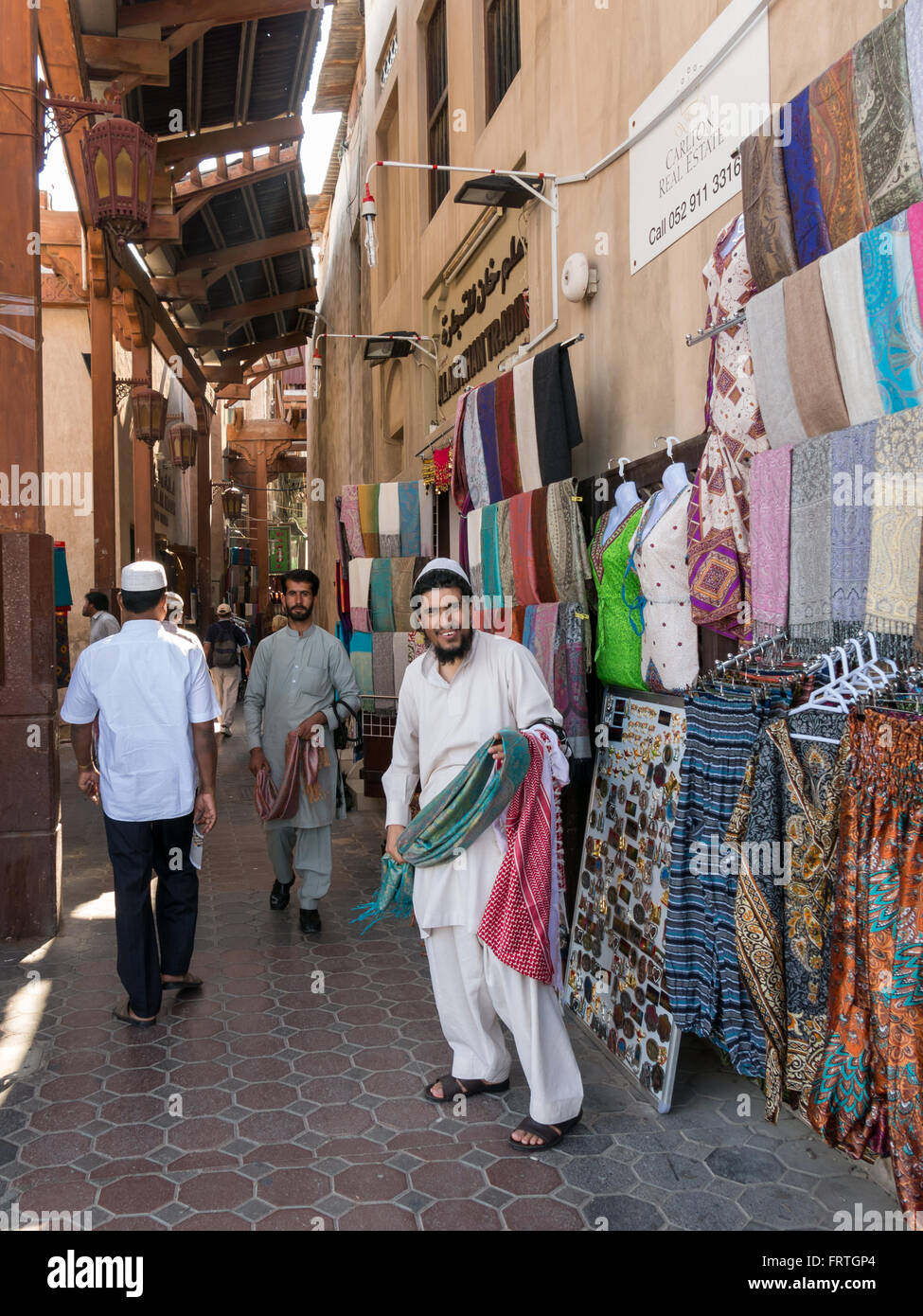 Shop salesmen in the ancient covered textile souk Bur Dubai in the old ...