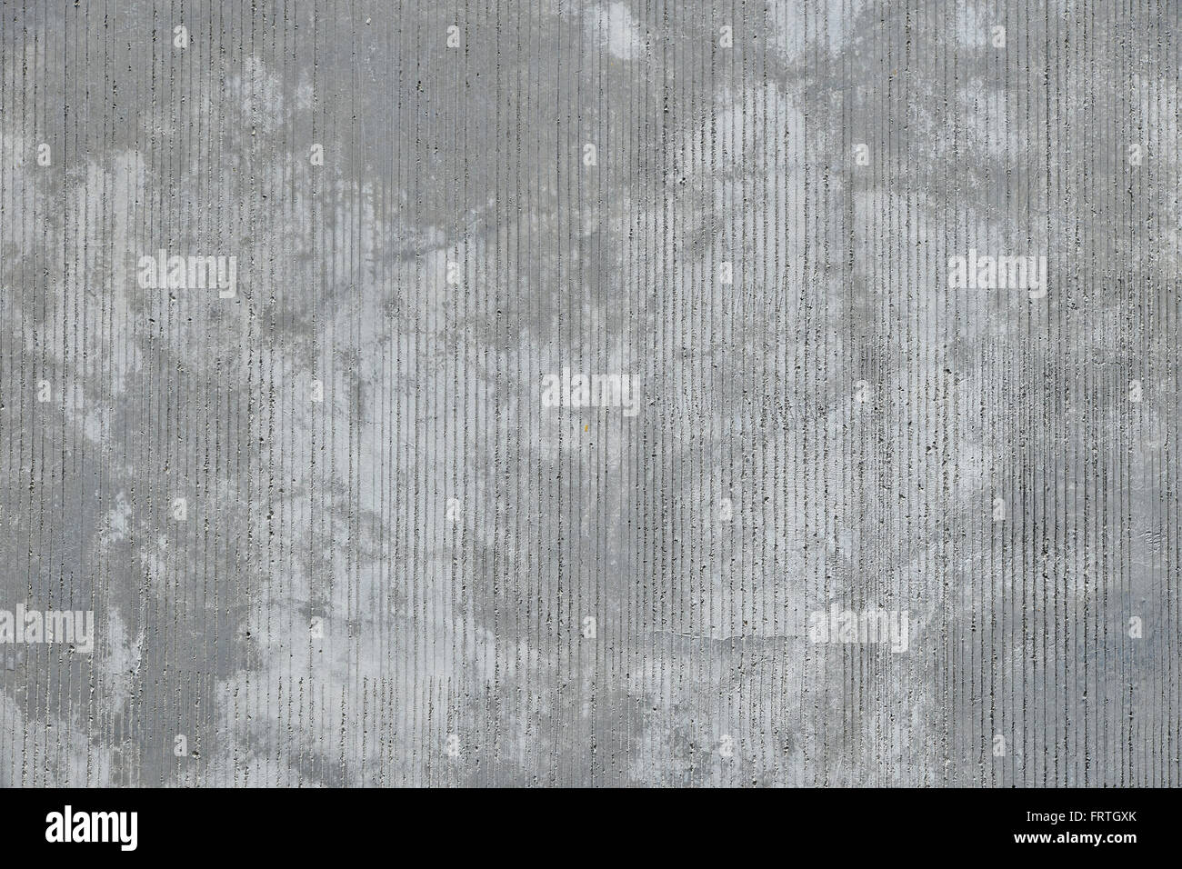 Grey concrete wall with parallel traces from rubbed finish processing ...
