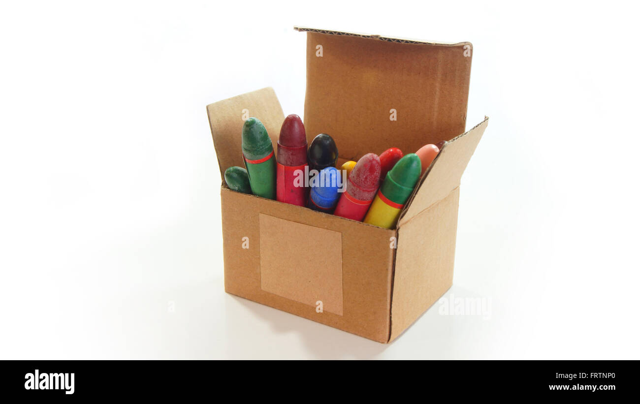Corrugated cardboard box open with crayons inside on white background ...