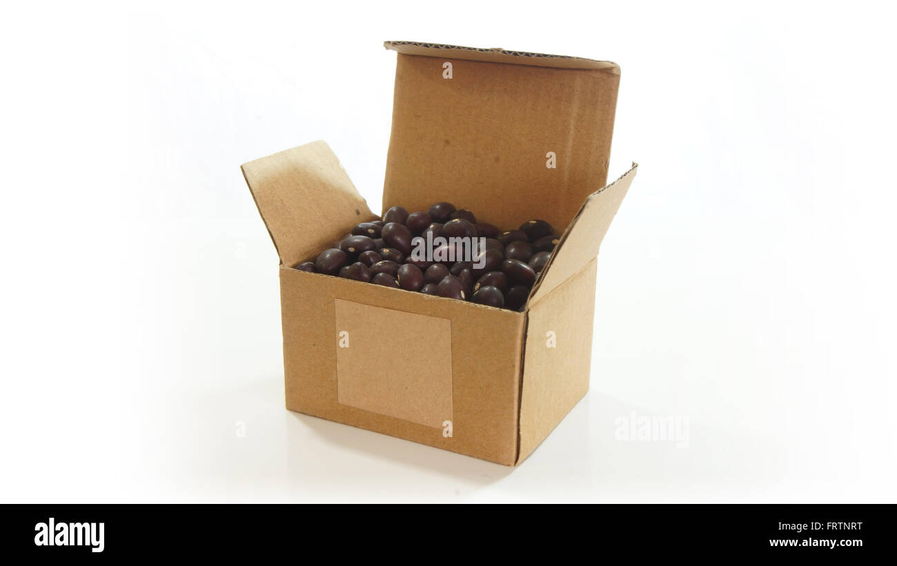 Corrugated cardboard box open with black beans (Phaseolus vulgaris ...
