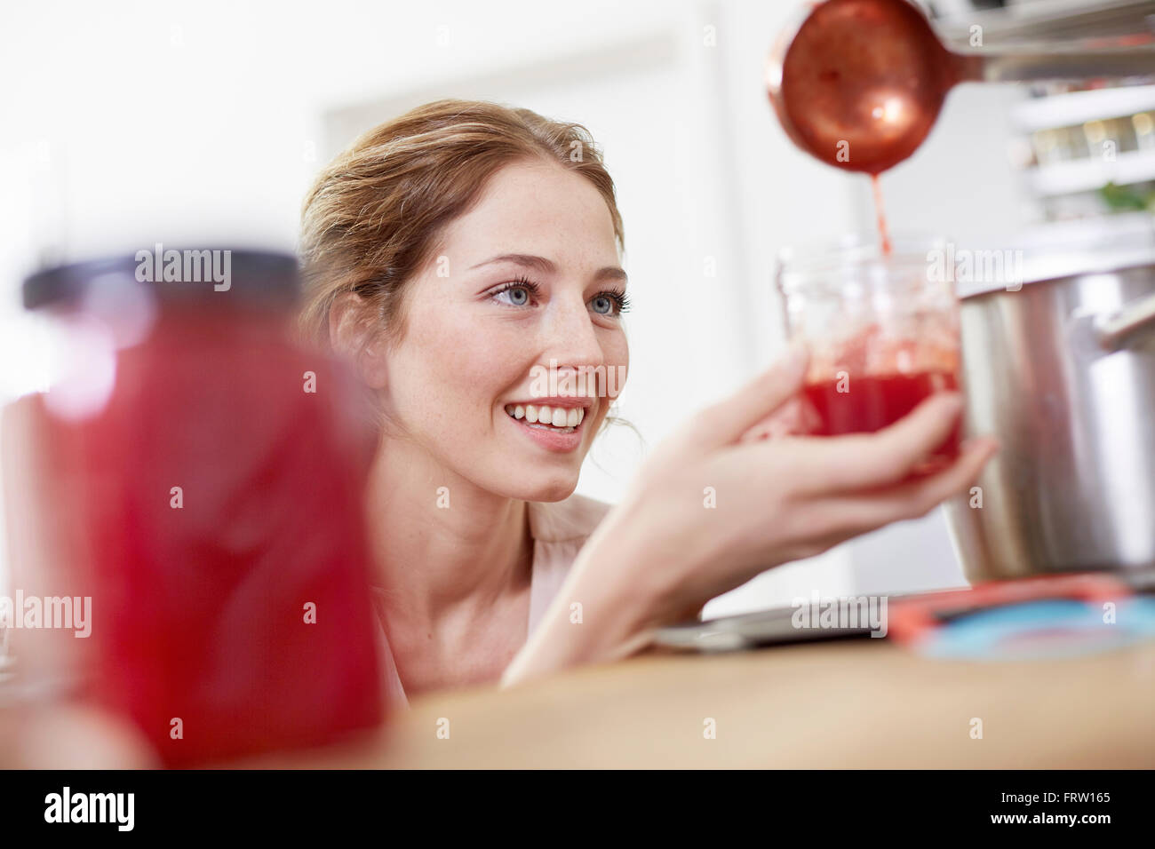Filling jam into jars Stock Photo - Alamy