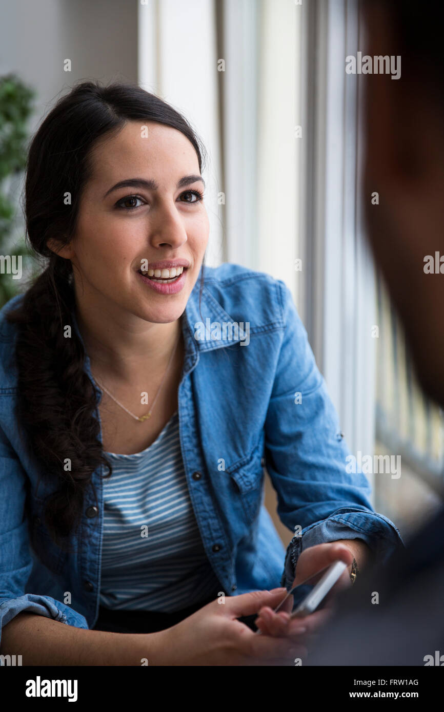 Woman at the window talking to man Stock Photo - Alamy