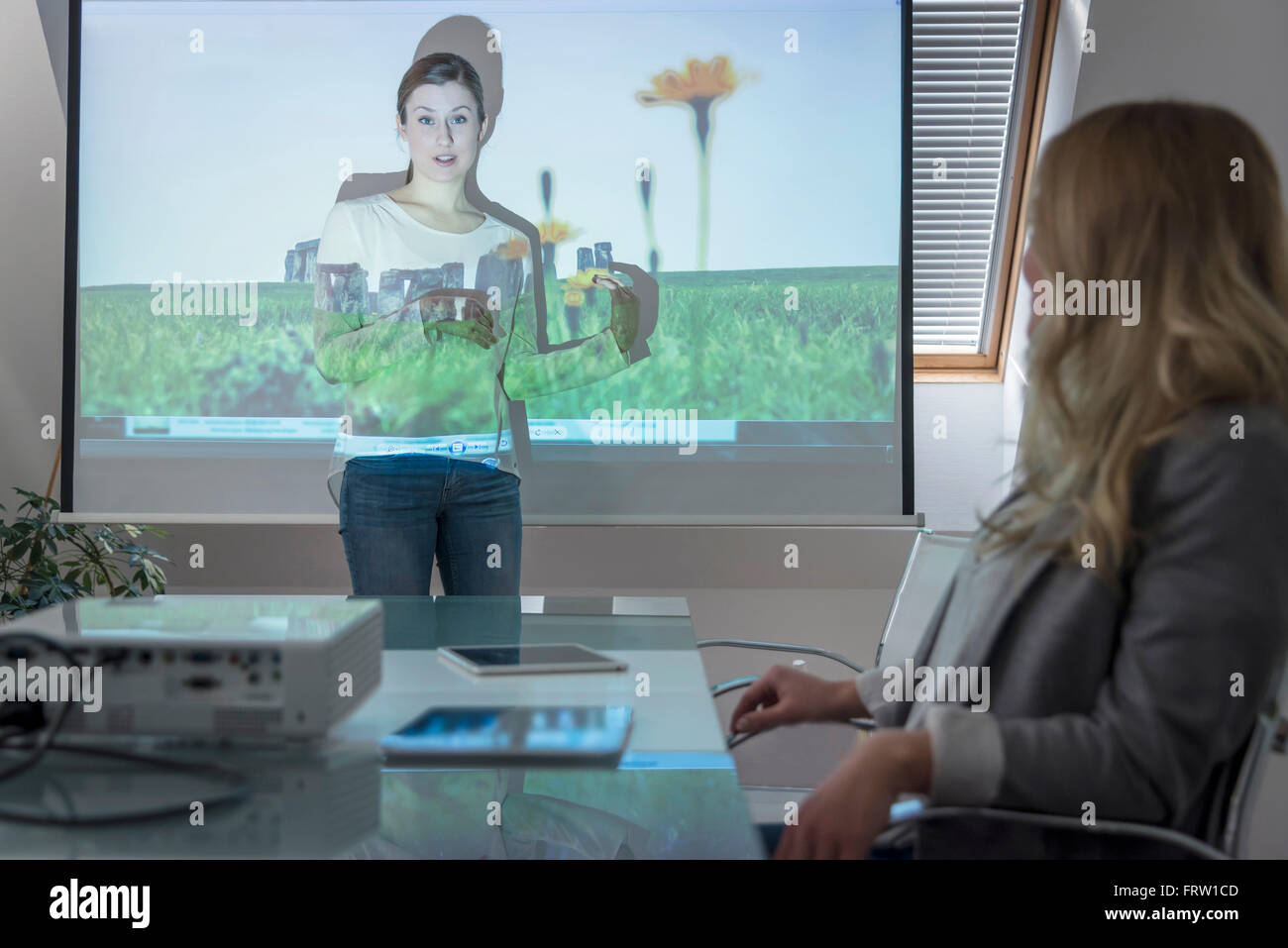 Woman leading a presentation with projector in conference room Stock ...