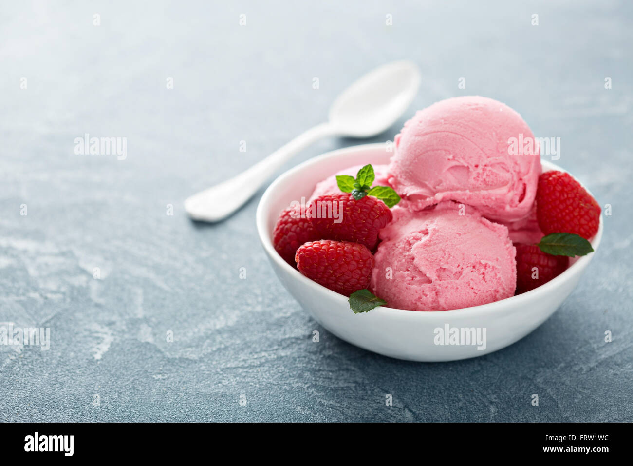 Raspberry ice cream in white bowl Stock Photo - Alamy