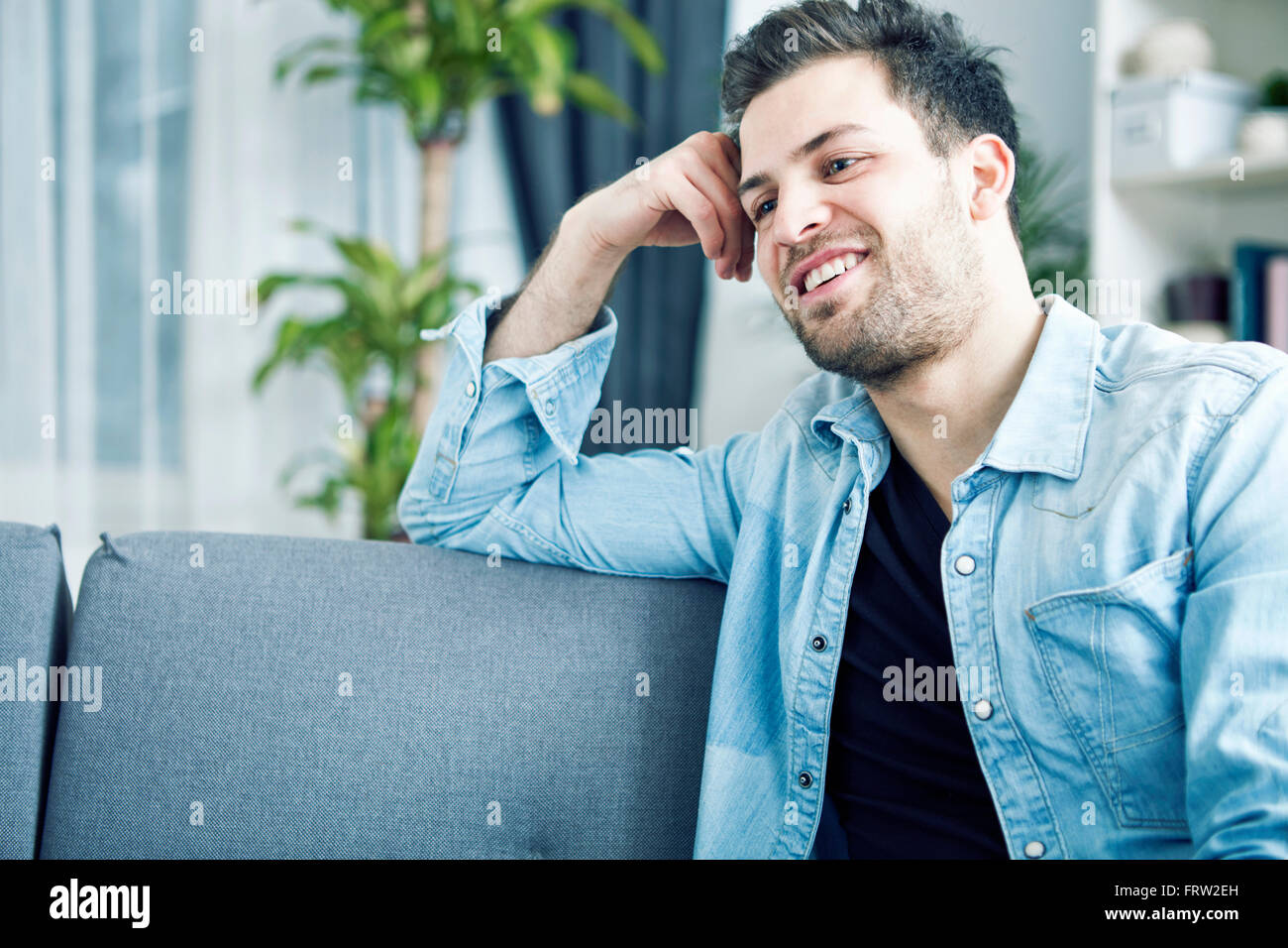 Relaxed young man at home Stock Photo - Alamy