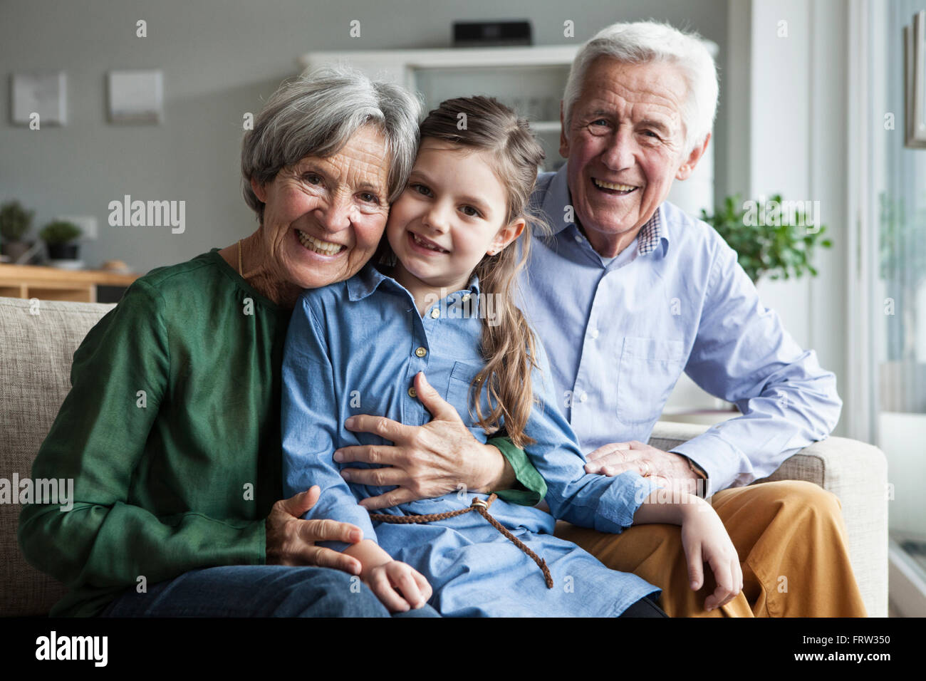 Family portrait of grandparents and their granddaughter at home Stock ...