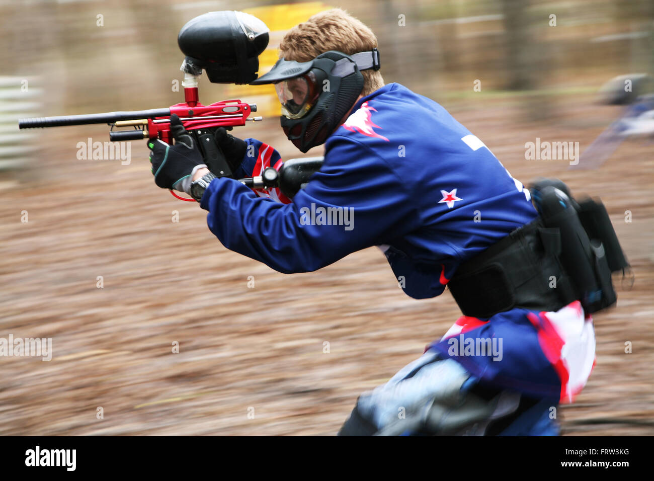The running person with a gun for paintball Stock Photo - Alamy