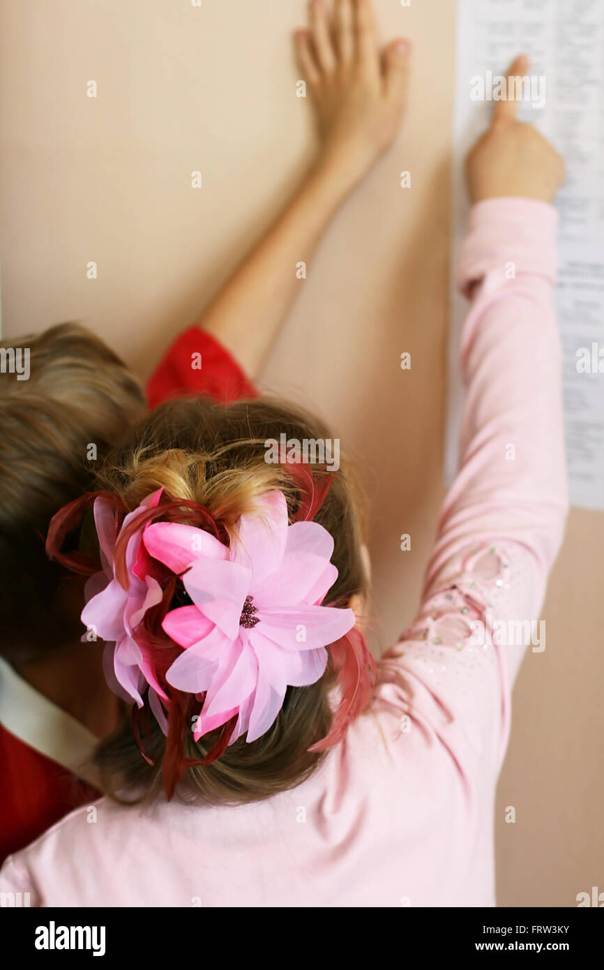 The boy and the girl at school look time-table of lessons Stock Photo ...