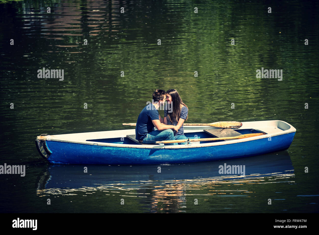 Lovers in rowing boat on water Stock Photo - Alamy