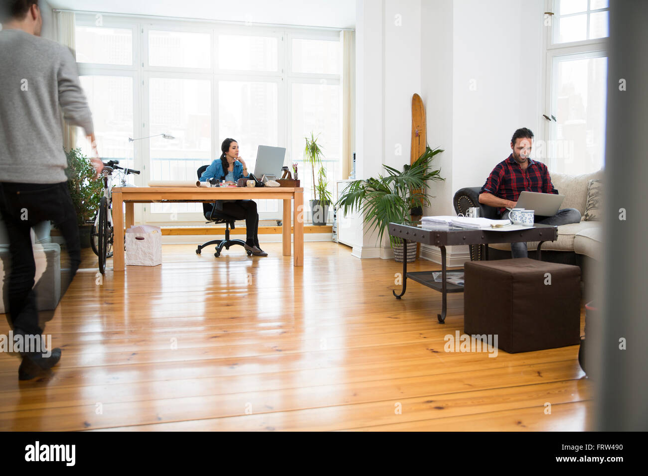 Three creative business people working in informal office Stock Photo ...