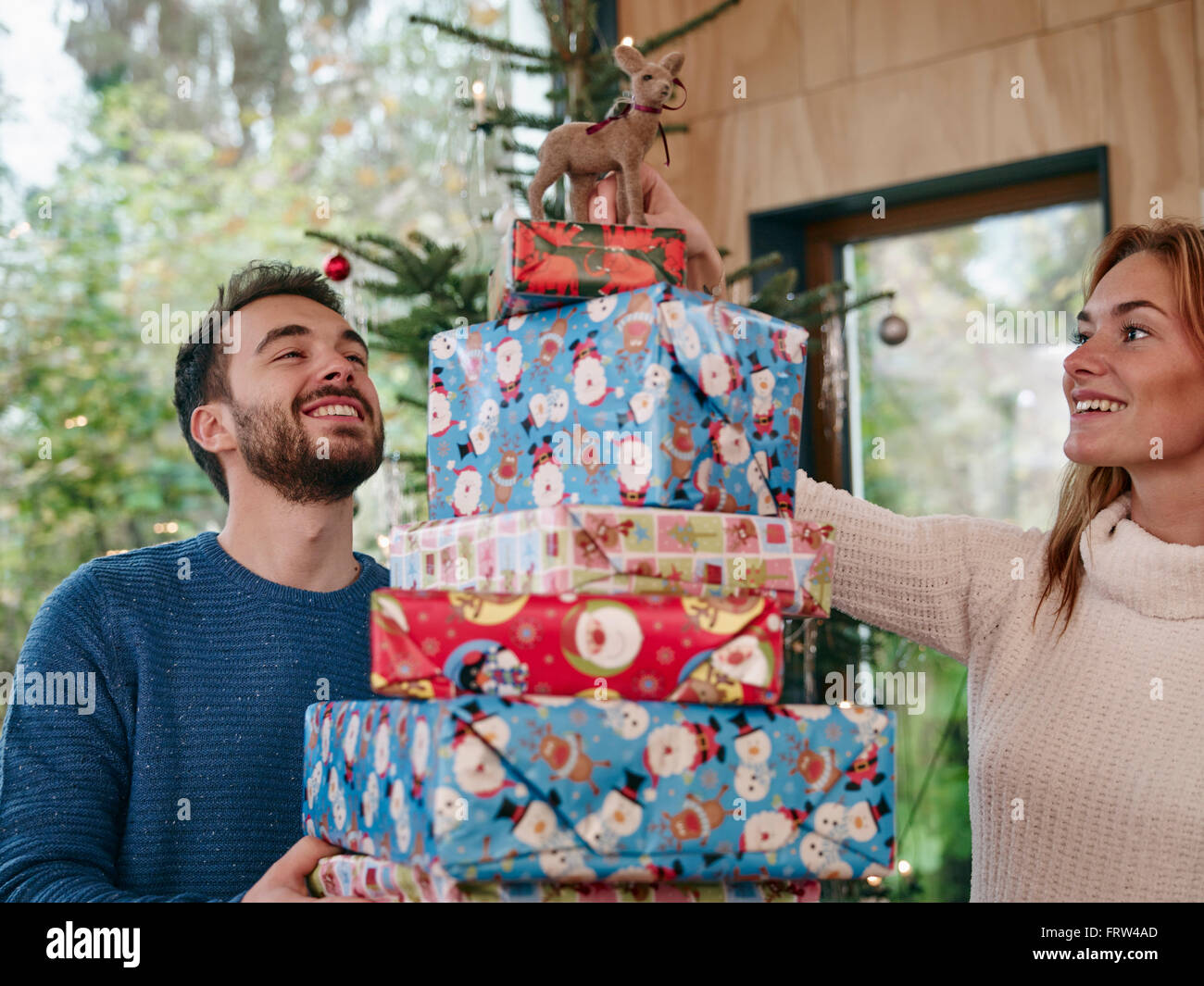 Man carrying stack christmas presents hi-res stock photography and ...