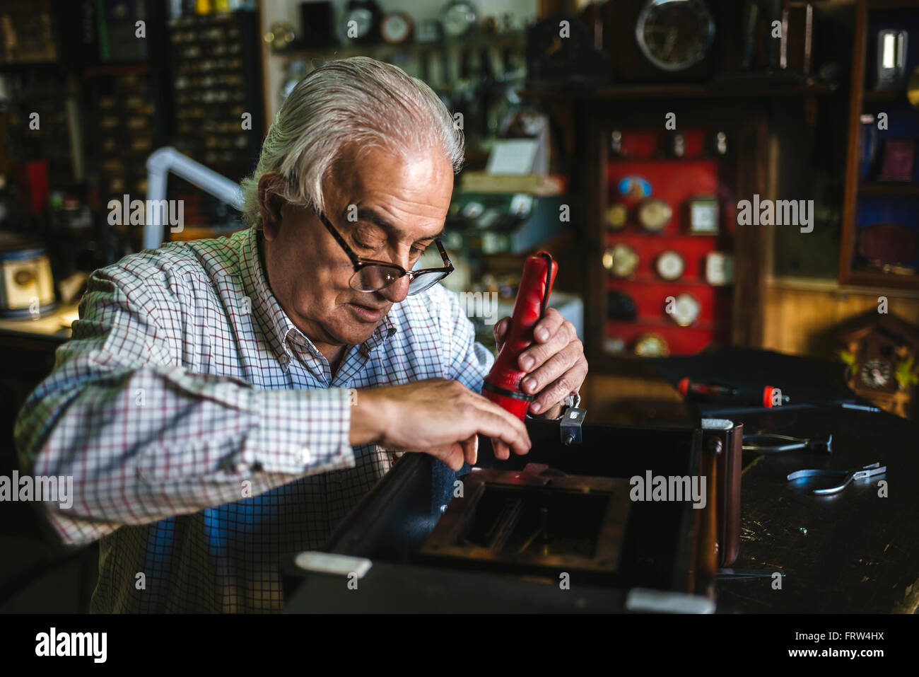 Watchmaker working in watchmaking Stock Photo - Alamy