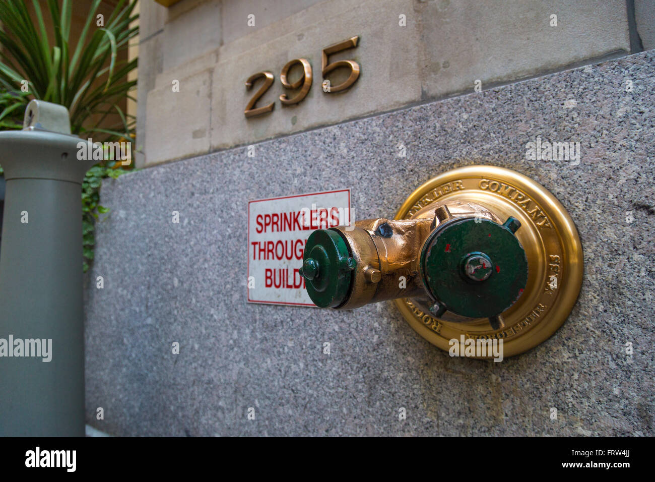 Golden fire hydrant sprinkler connection in a wall in New York City ...