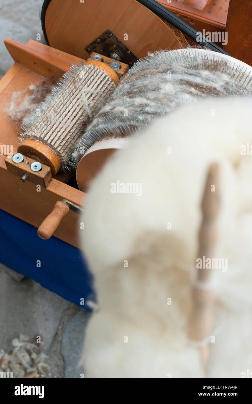 Manual processing of wool on a vintage machine Stock Photo - Alamy