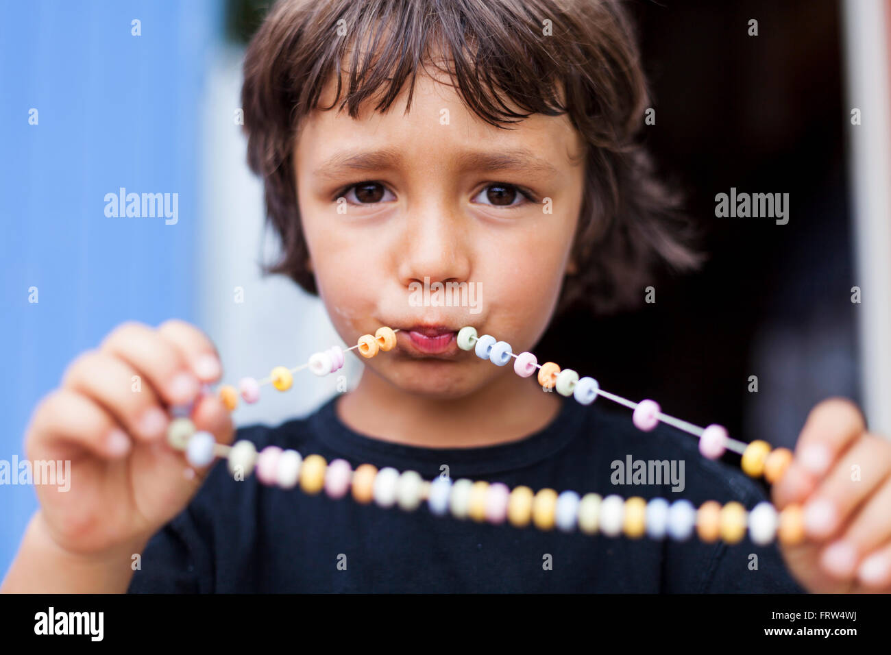 Portrait of little boy with necklace of Hundreds and Thousands Stock ...