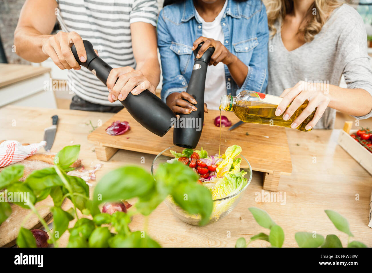 Friends preparing salad Stock Photo - Alamy
