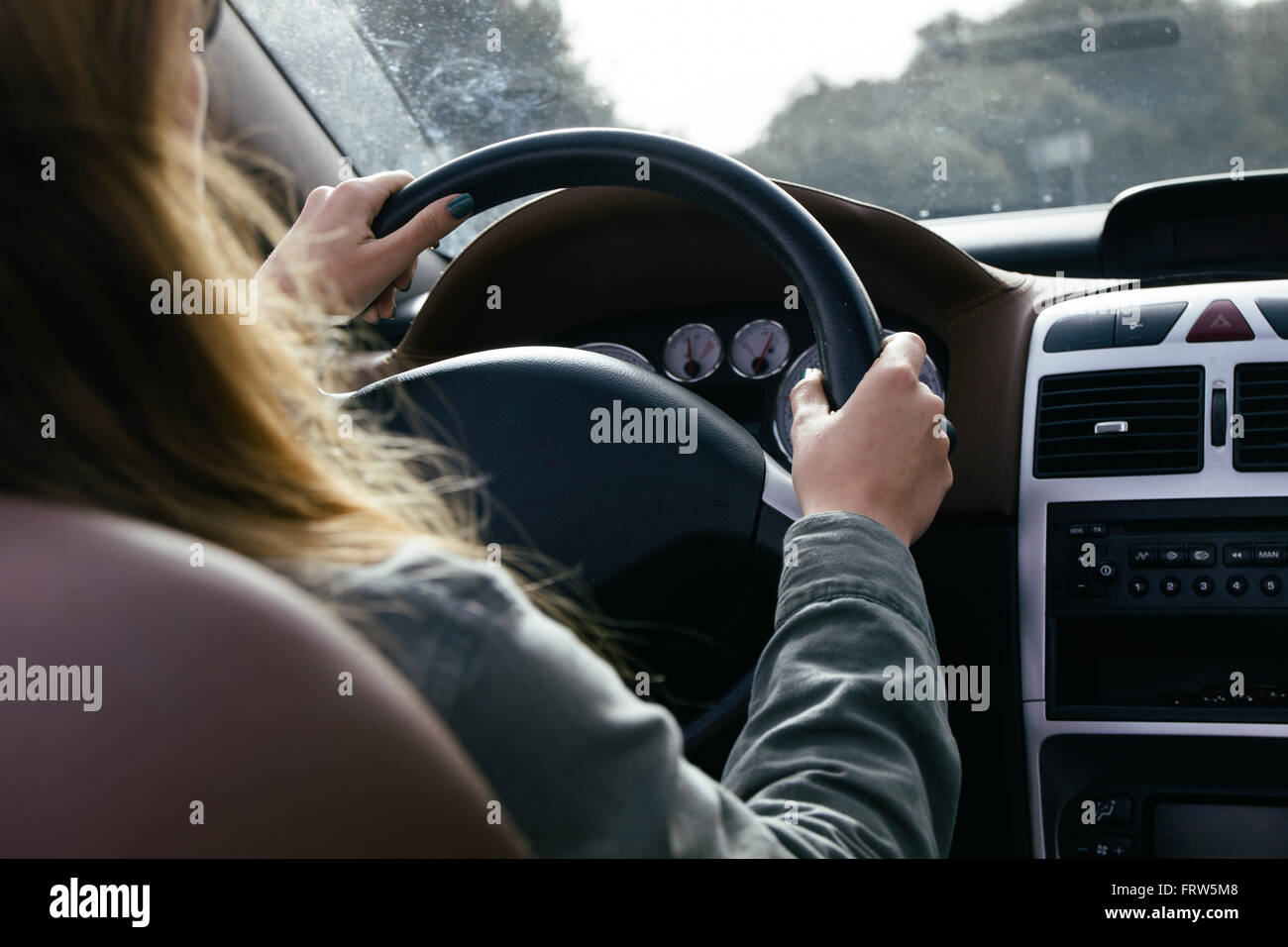 Young woman driving car Stock Photo - Alamy