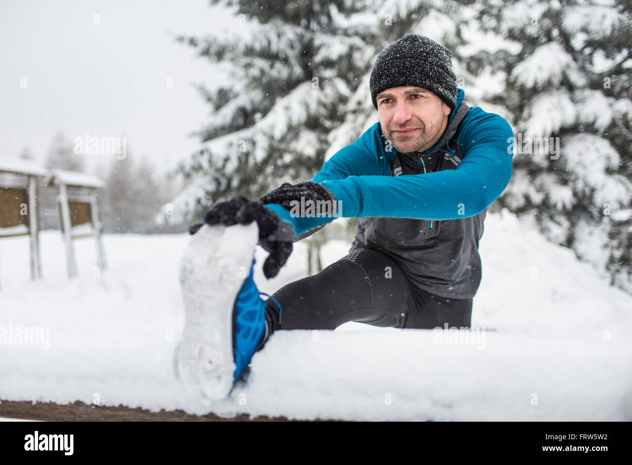 Man stretching on fence hi-res stock photography and images - Alamy