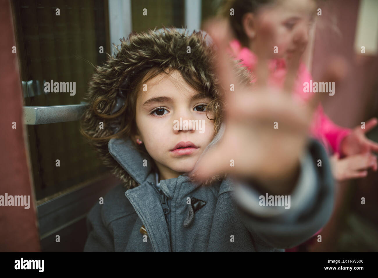 Portrait of little girl showing stop gesture Stock Photo - Alamy