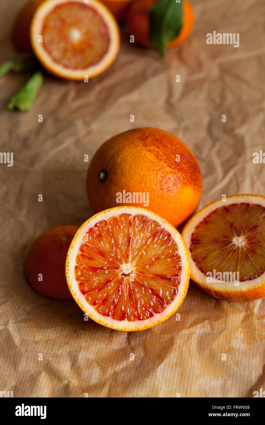Whole and sliced blood orange on crumpled brown paper Stock Photo - Alamy