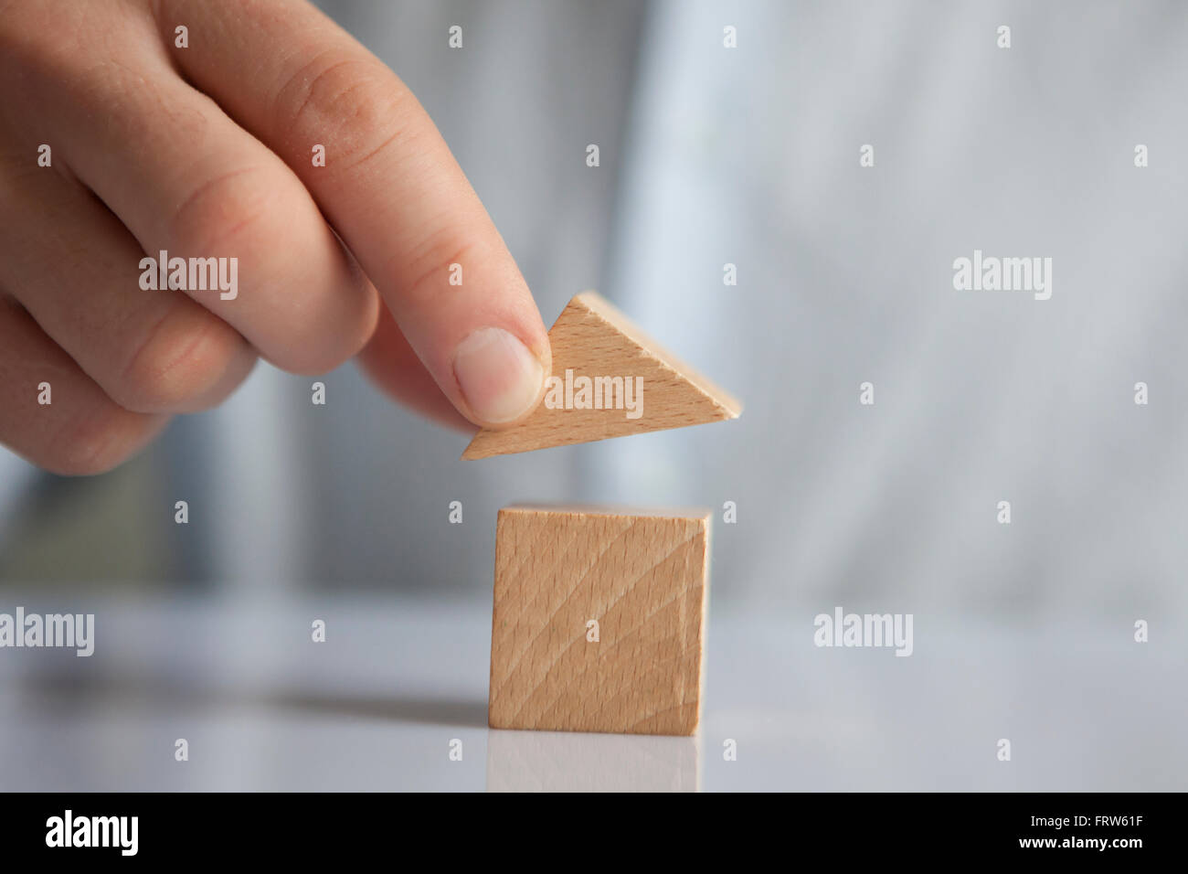 Man building up house with building blocks, close-up Stock Photo - Alamy
