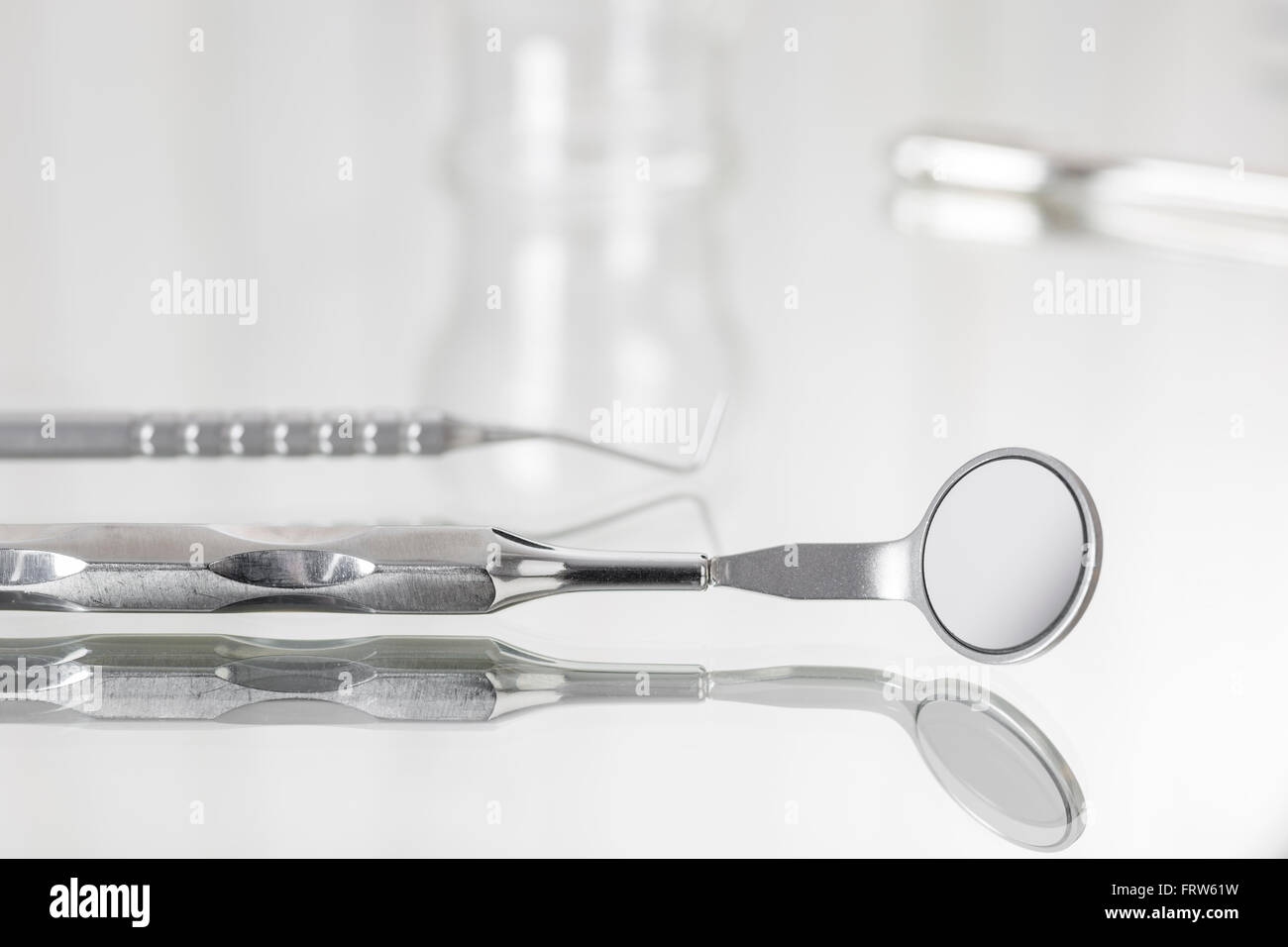 Mirrow and probe on glass, dental instruments Stock Photo - Alamy
