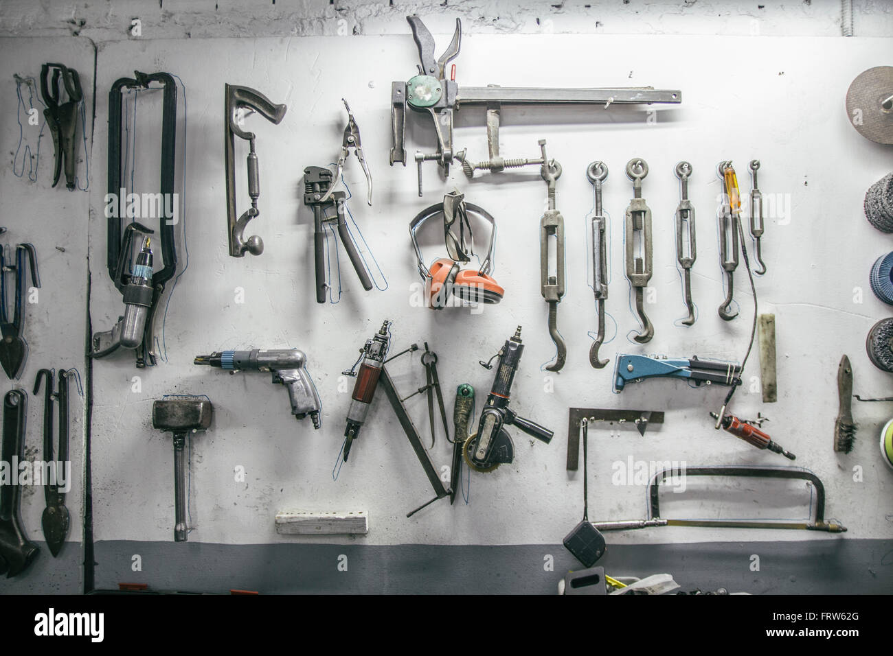 Tools hanging on the wall of a workshop Stock Photo - Alamy
