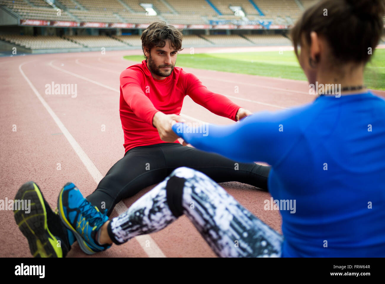 Athletes training for race in stadium Stock Photo - Alamy