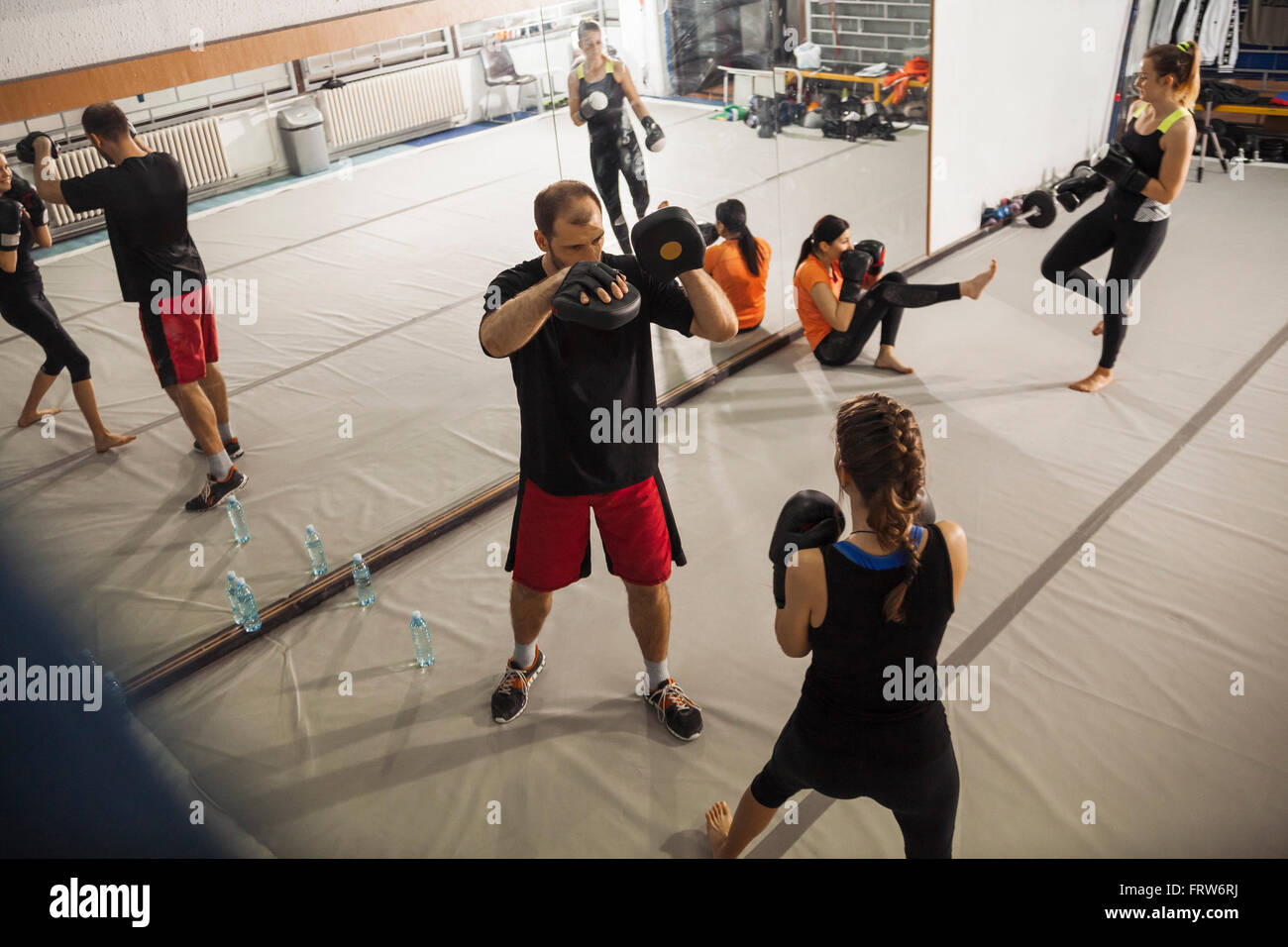 Female boxer sparring with coach Stock Photo - Alamy