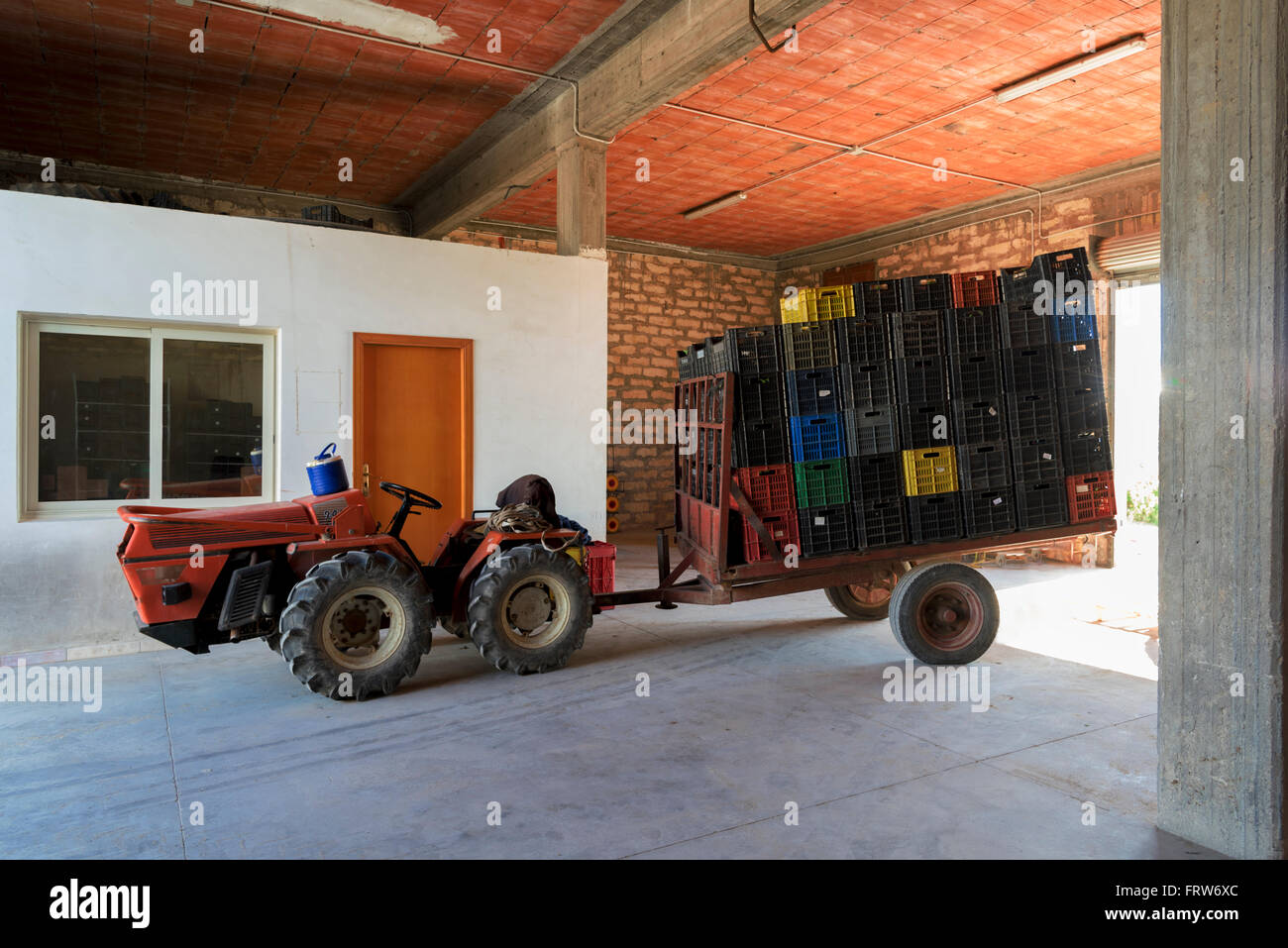 Tractor with stacks of boxes on trailer Stock Photo - Alamy