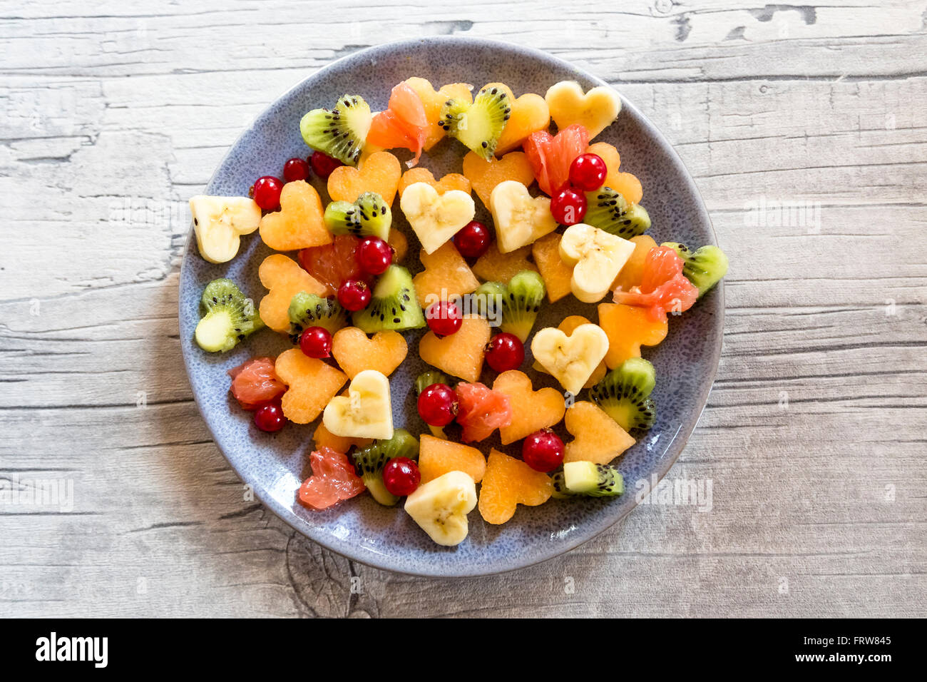 Plate of different heart-shaped fruit pieces Stock Photo - Alamy