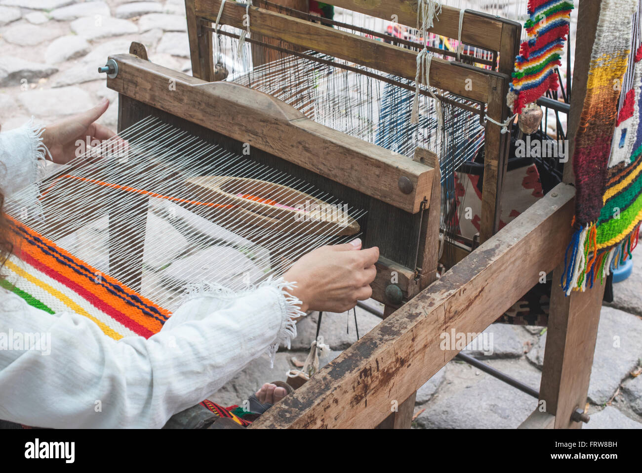 Woman weaving carpet with weaving loom Stock Photo - Alamy